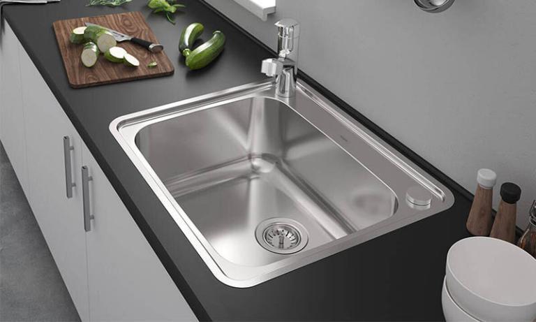 What is the kitchen sink made of? Stainless steel, ceramic, or granite